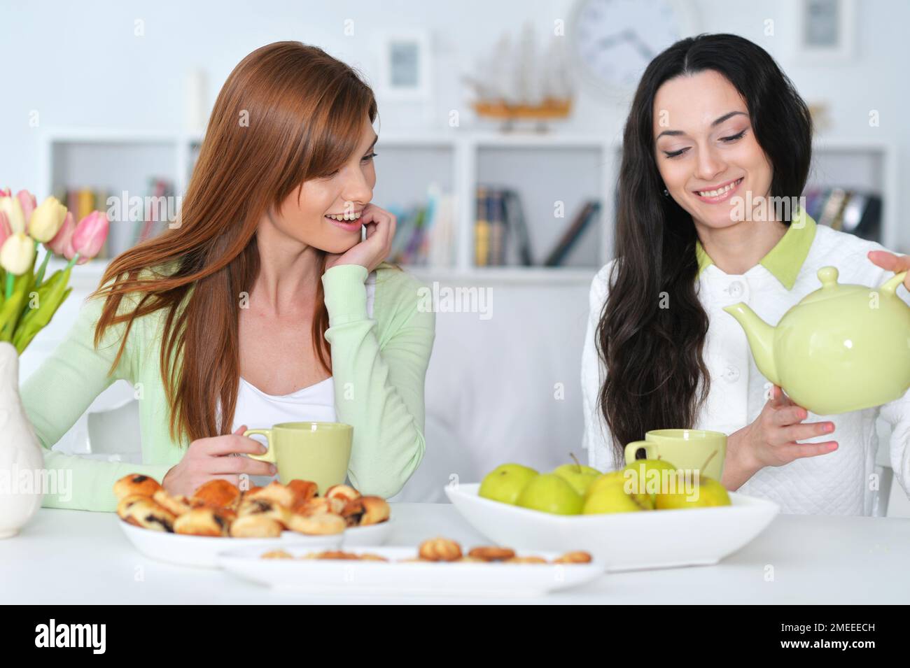 two female friends drinking tea Stock Photo - Alamy