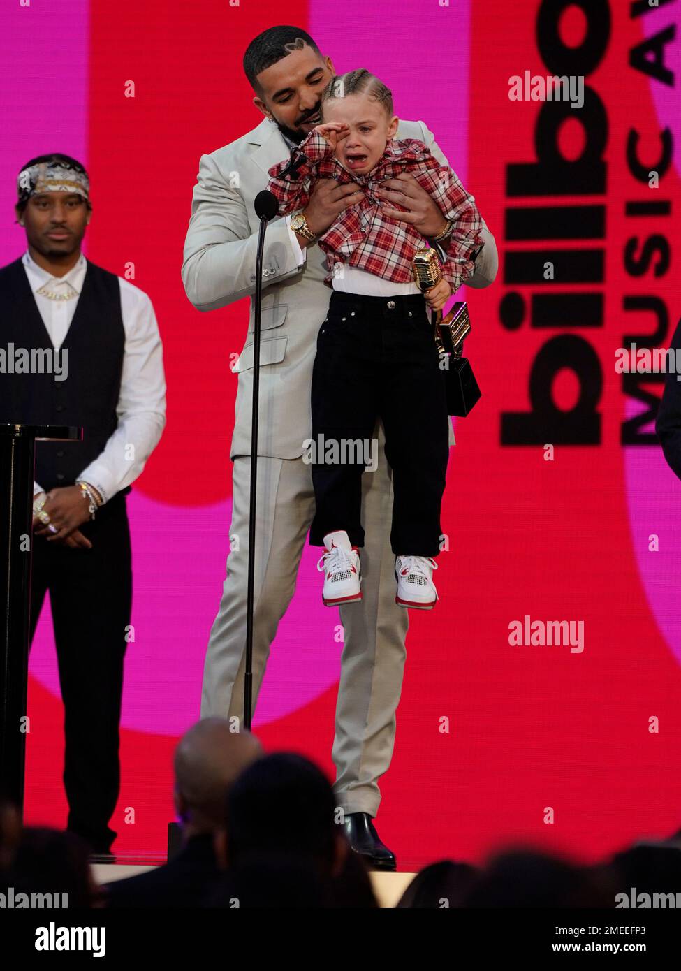 Drake carries his son Adonis Graham as he accepts the artist of the ...