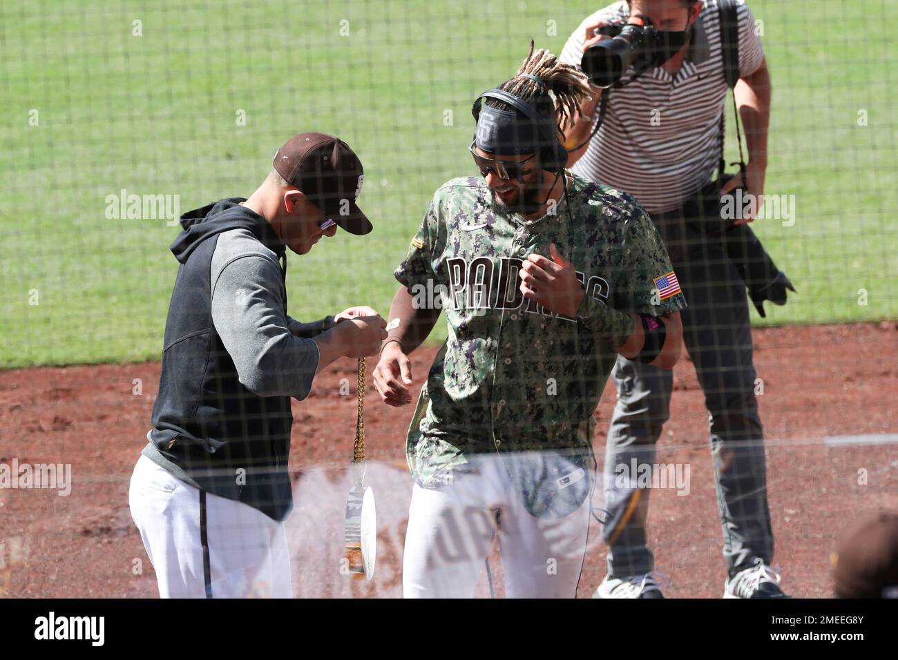San Diego Padres' Manny Machado, left, brings Fernando Tatis Jr., right ...