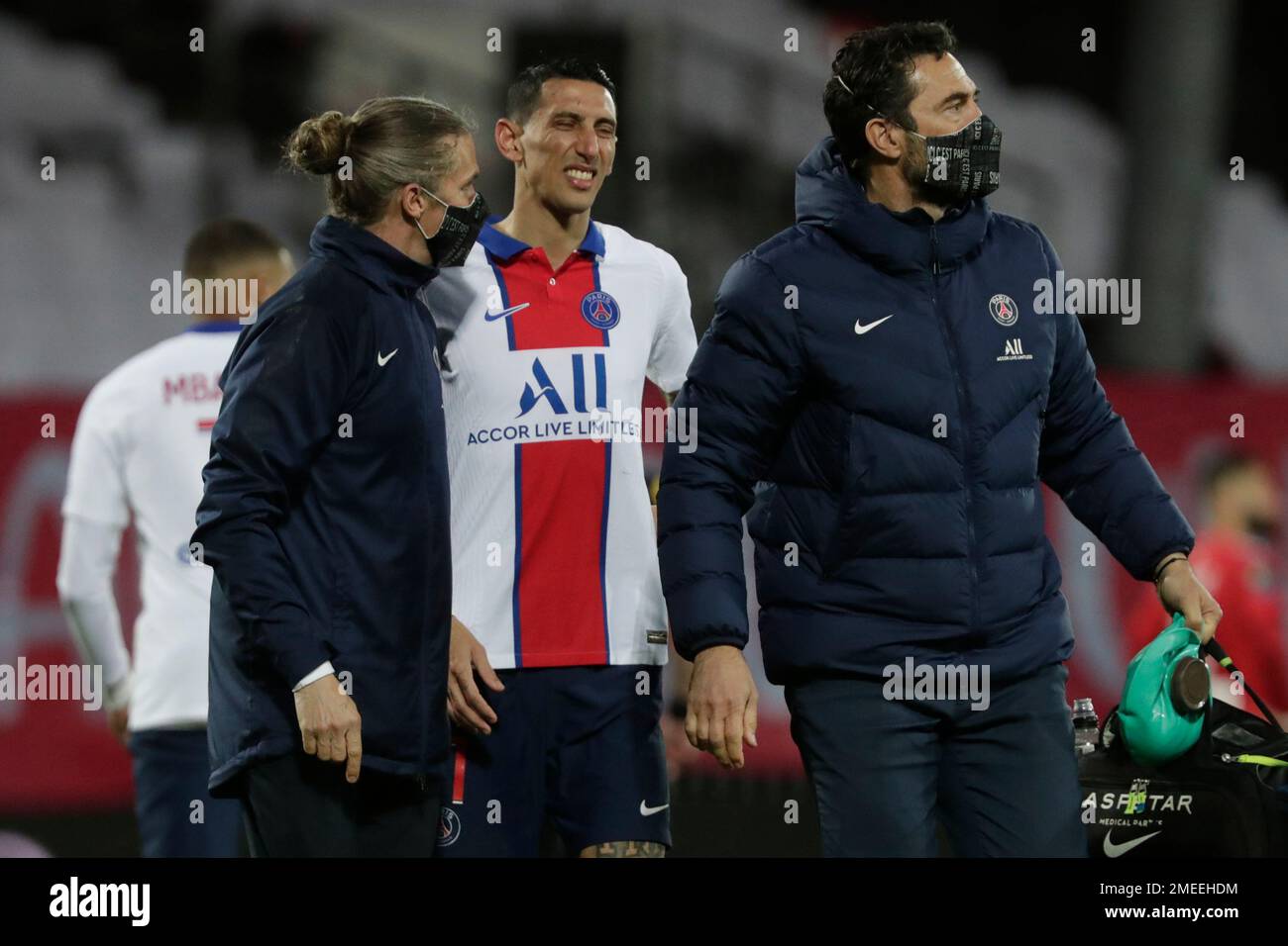 PSG's Angel Di Maria, center, grimaces in pain after an injury during ...