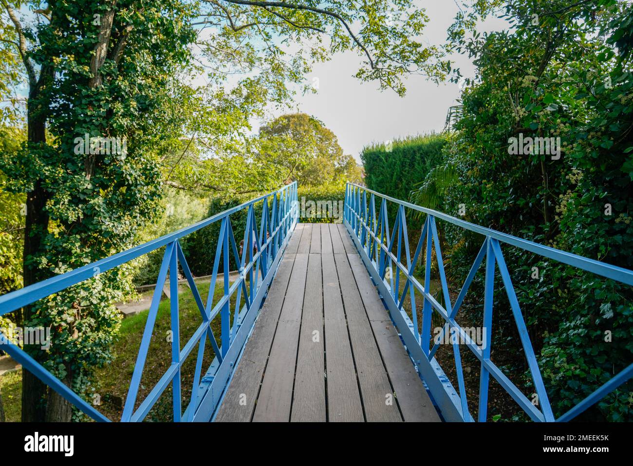 Bridge wooden walkway with blue metal protection Stock Photo - Alamy