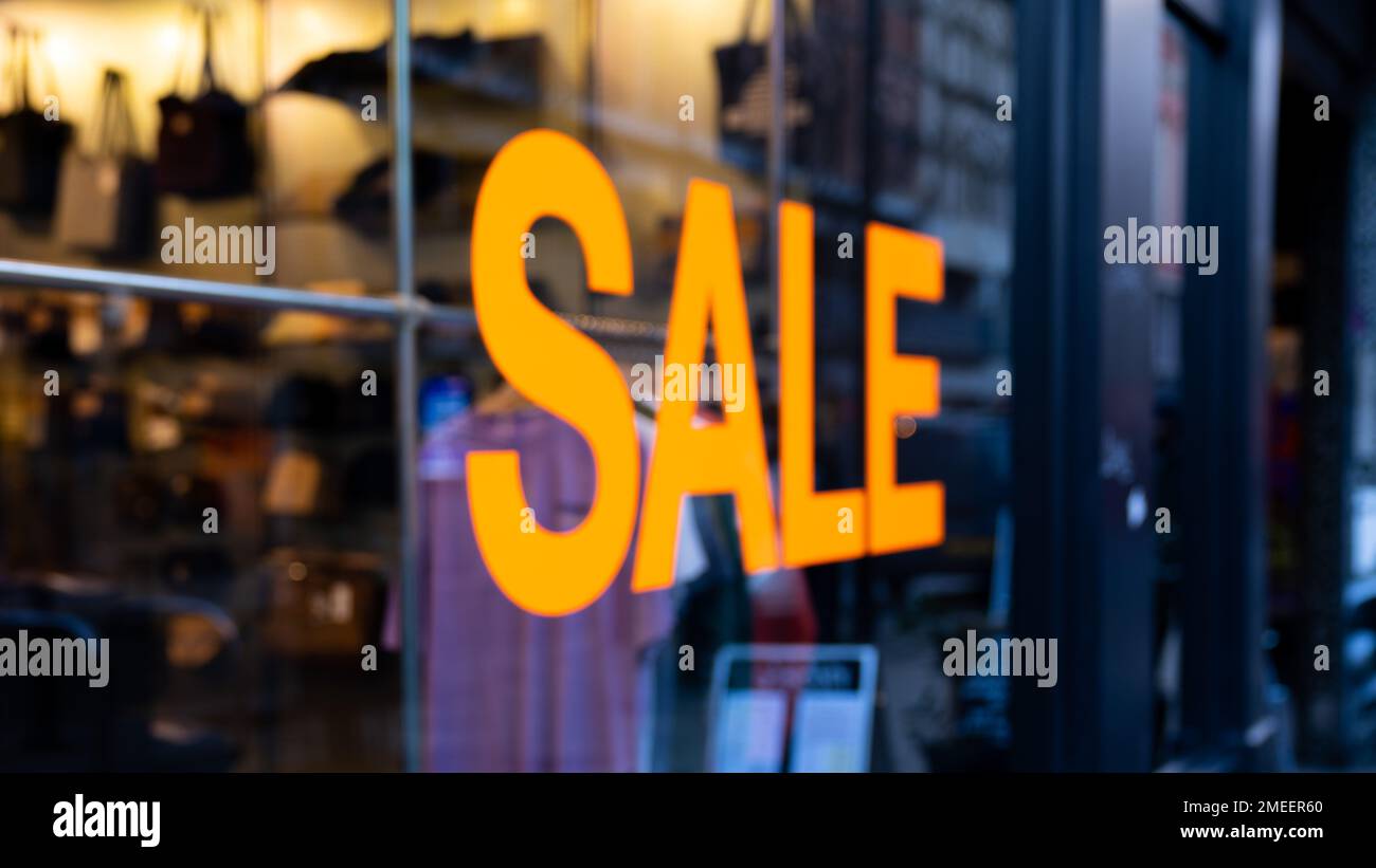 Shop window displaying large sale sign Stock Photo - Alamy