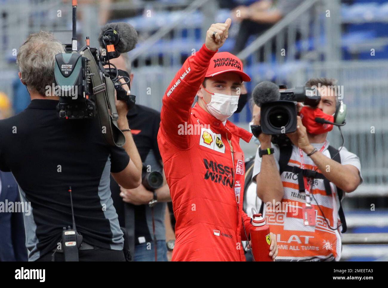 Ferrari driver Charles Leclerc of Monaco, center, gives the thumbs up ...
