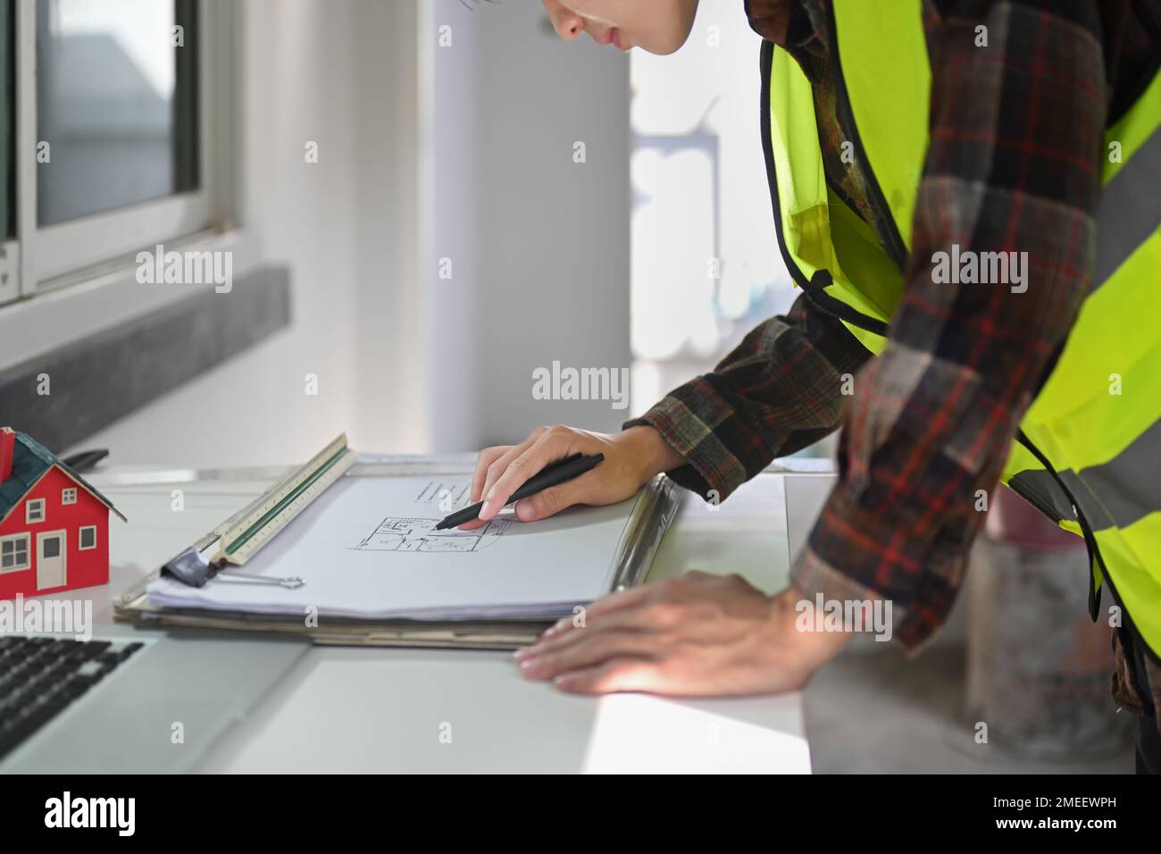 Engineer man working at blueprints and checking building construction ...
