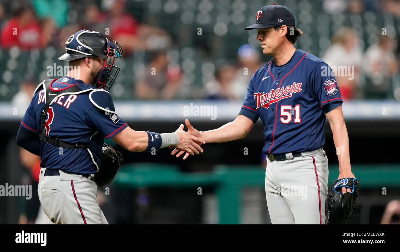 Minnesota Twins relief pitcher Luke Farrell, right, is congratulated by ...