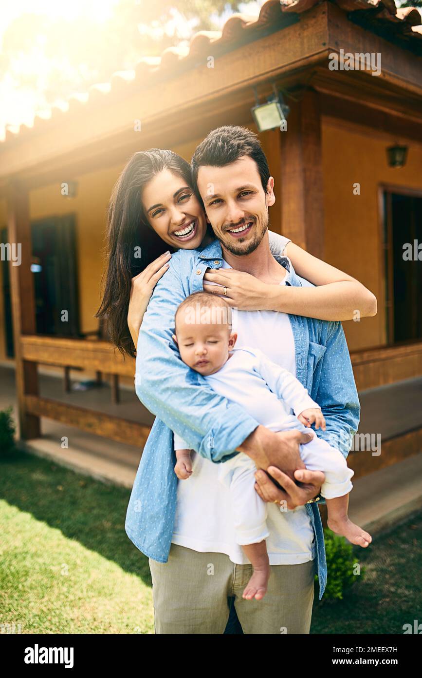 And three makes a family. Cropped portrait of a happy young family of ...