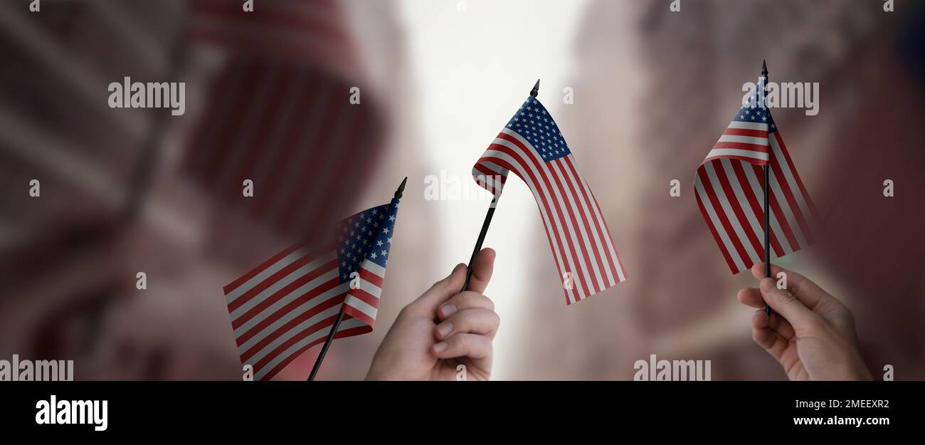 A group of people holding small flags of the USA in their hands Stock ...