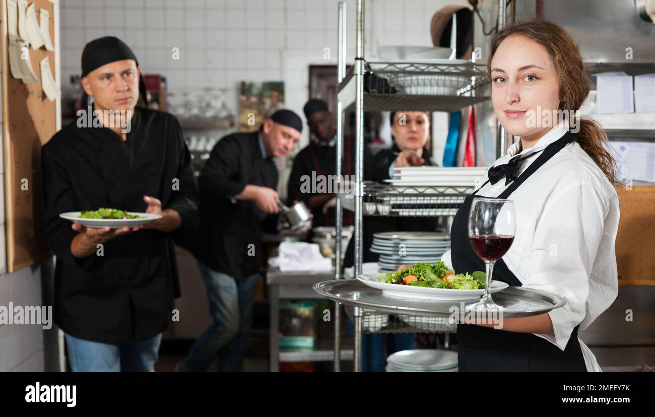 Professional waitress holding dish hi-res stock photography and images ...