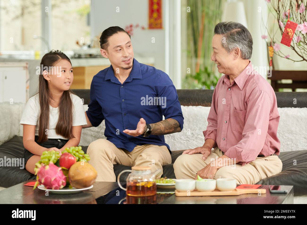 Teenge girl, father and grandfather spending Chinese New Year together ...