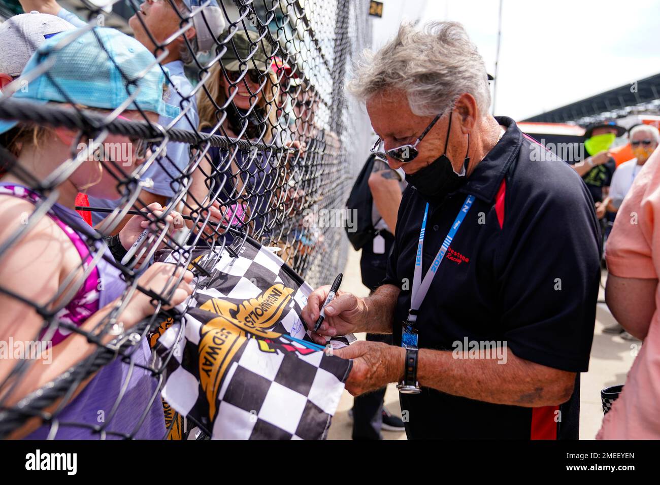 1969 Indianapolis 500 champion Mario Andretti signs autographs for fans ...