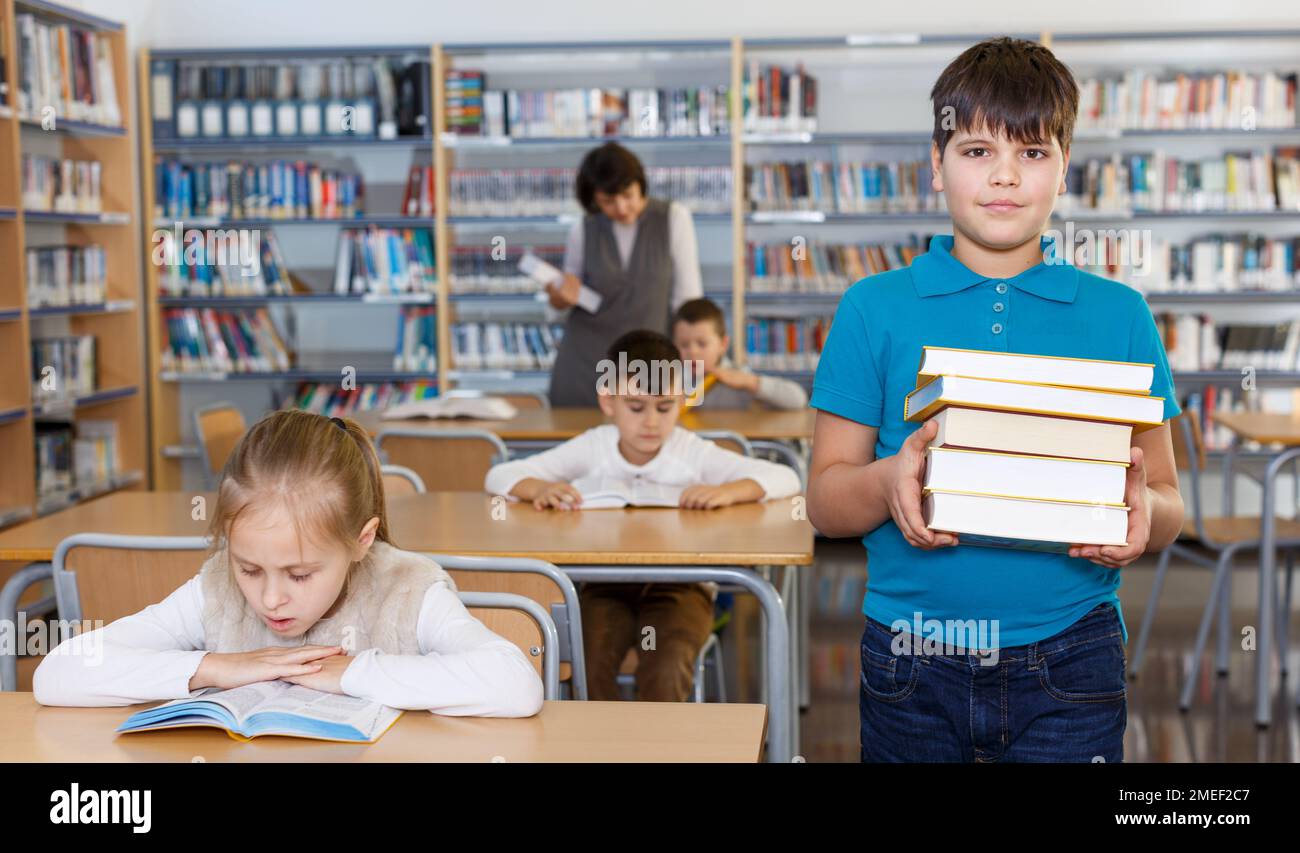 Boy studying pile of books hi-res stock photography and images - Alamy
