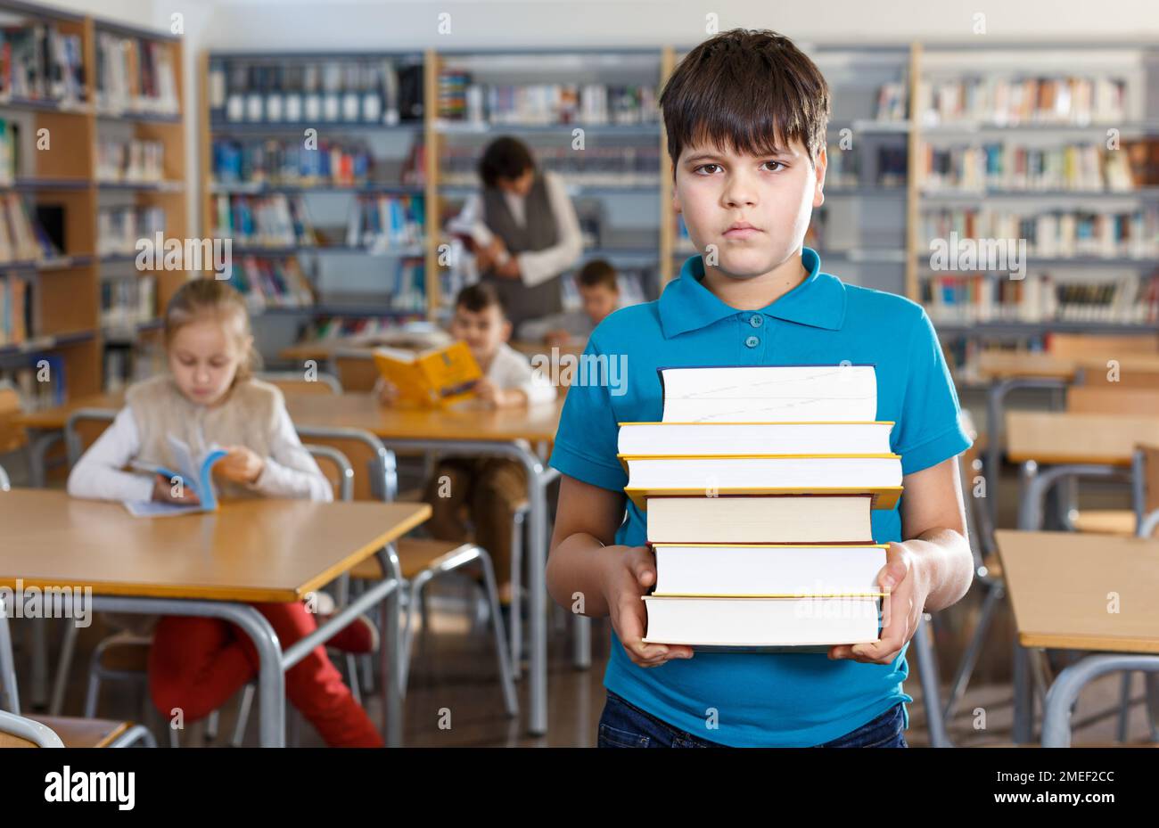 Frustrated boy with stack of books hi-res stock photography and images ...