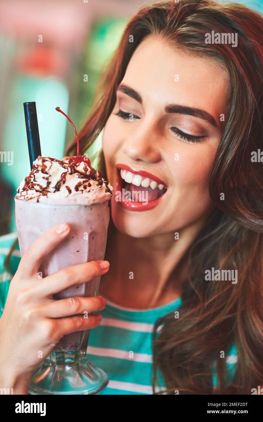 This milkshake is the cherry top to my day. a beautiful young woman ...