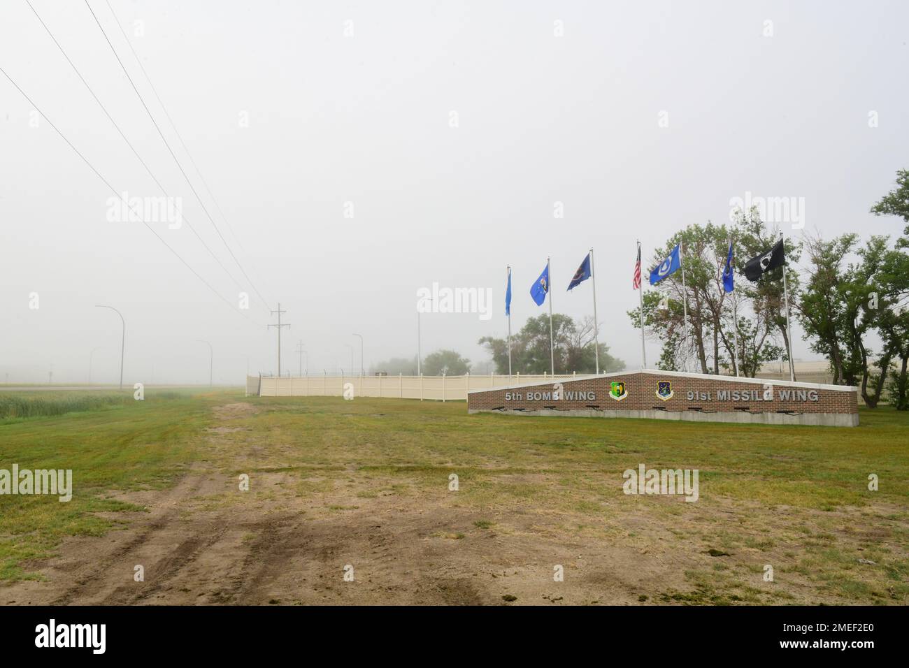 Heavy fog covers a sign at the front of the base entrance at Minot Air ...