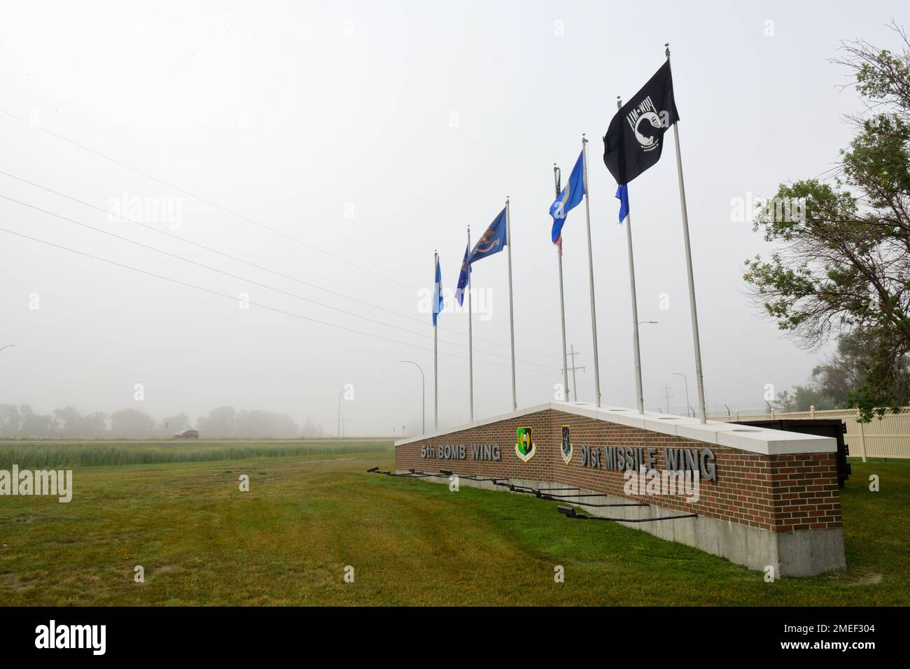 Heavy fog covers a sign at the front of the base entrance at Minot Air ...
