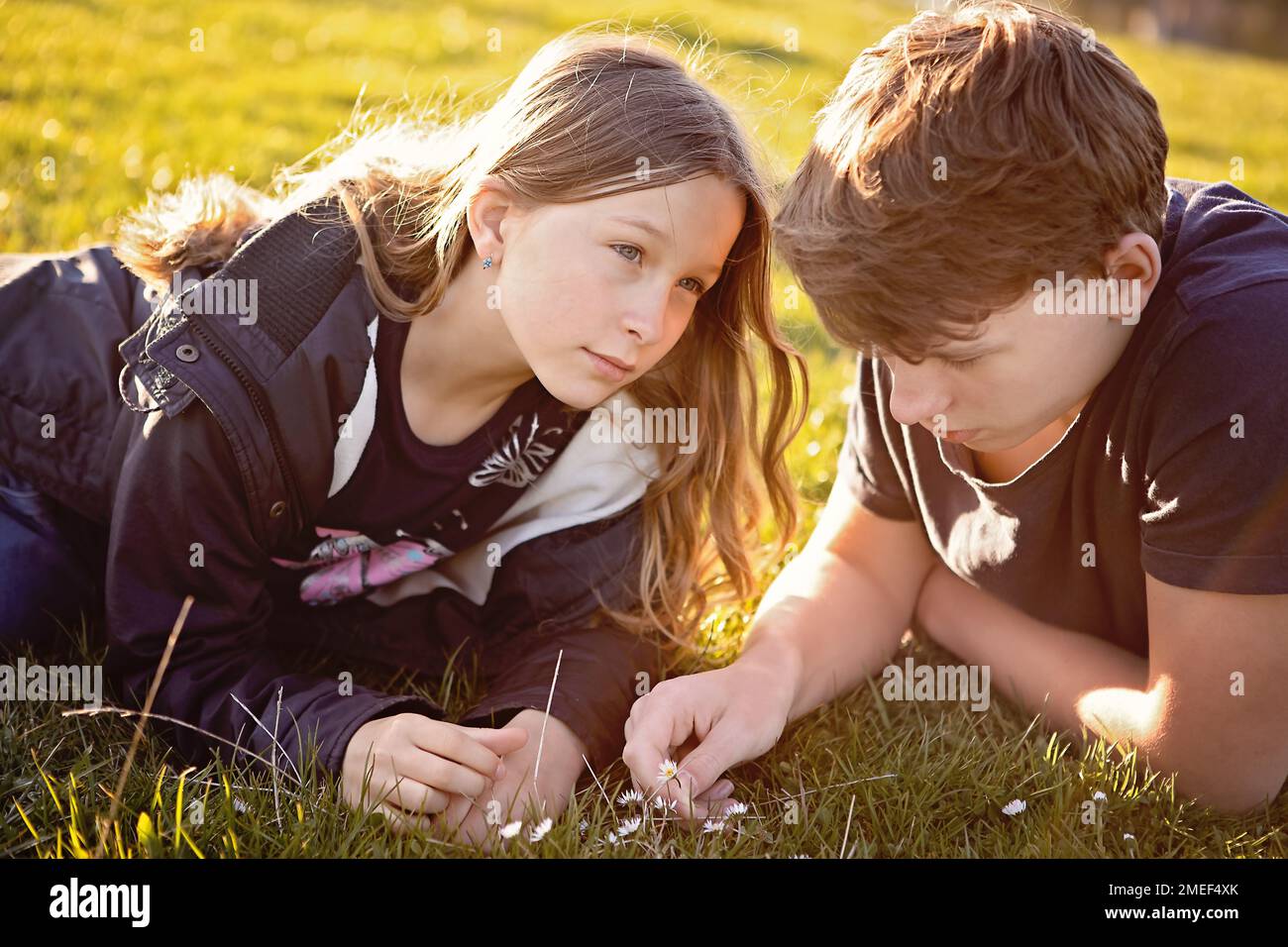 Brother and sister, siblings, boy and girl, children during sunset, on ...