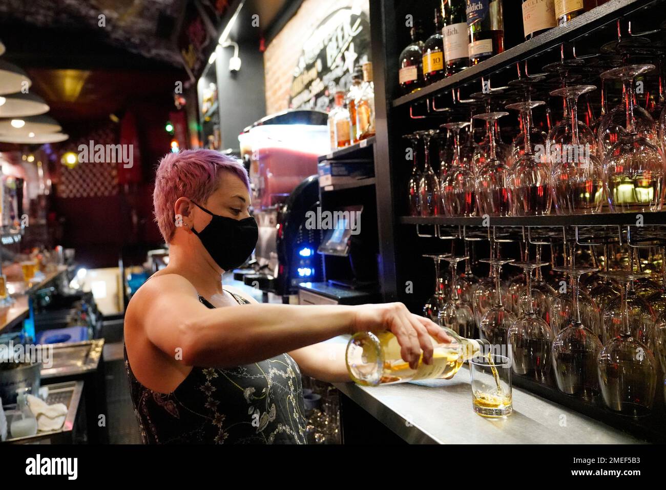 e's Bar owner Erin Bellard pours a drink for a customer at her bar on ...