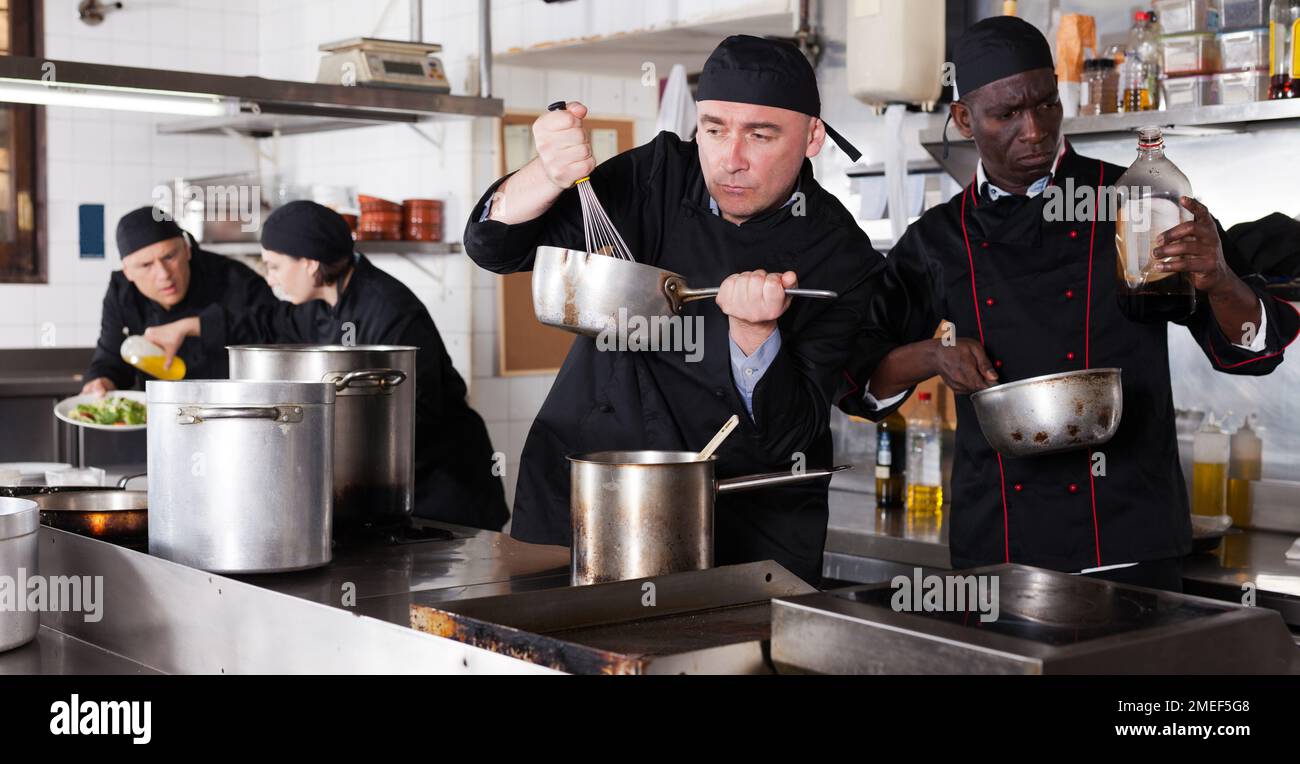 Chef in professional kitchen cooks hi-res stock photography and images ...