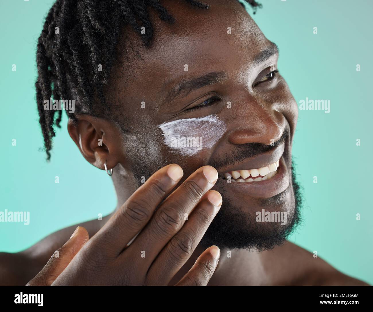Black man, face and cream, happy with smile and beauty, moisturizer for skincare isolated on ...