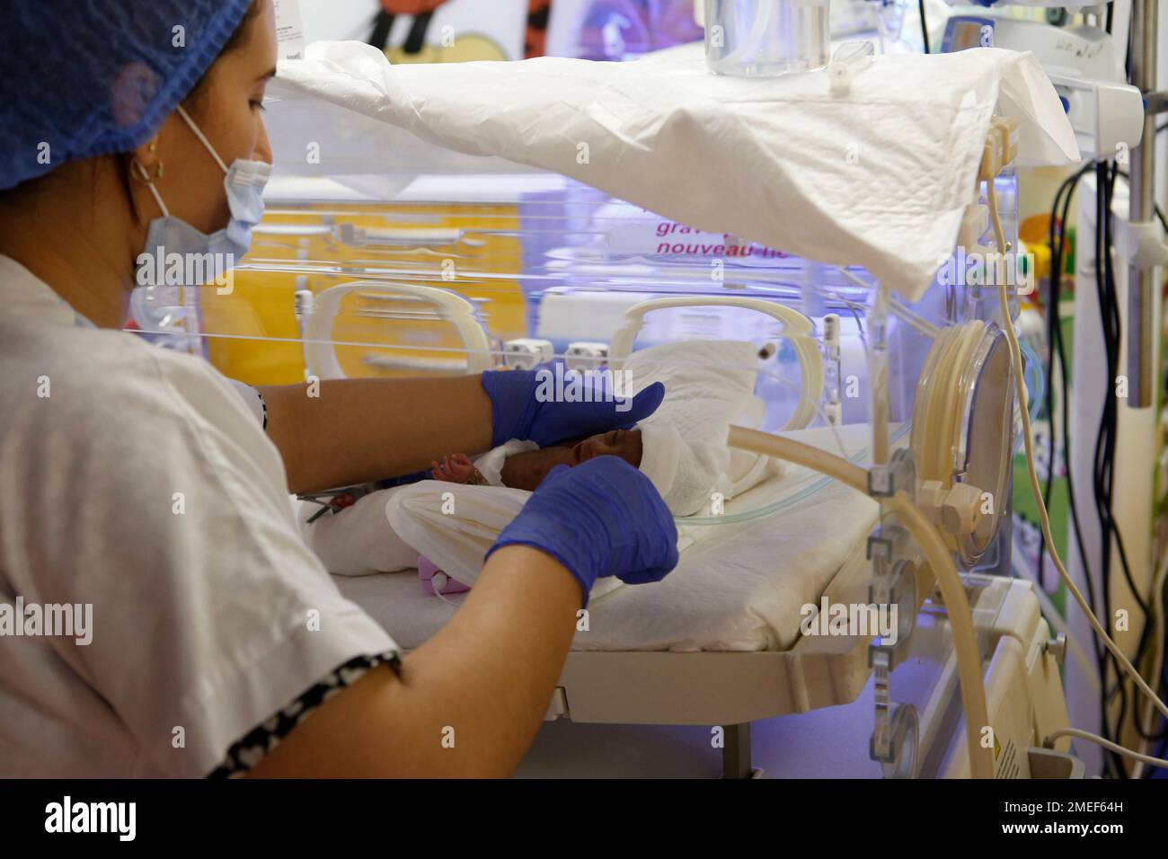 A Moroccan nurse takes care of one of the nine babies protected in an ...