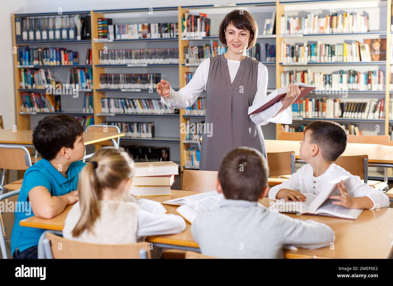 Female teacher giving lesson to school kids Stock Photo - Alamy