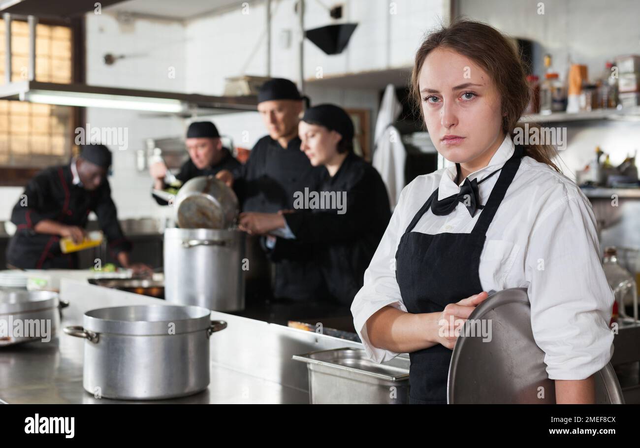 Tired and upset waitress in kitchen of restaurant Stock Photo - Alamy