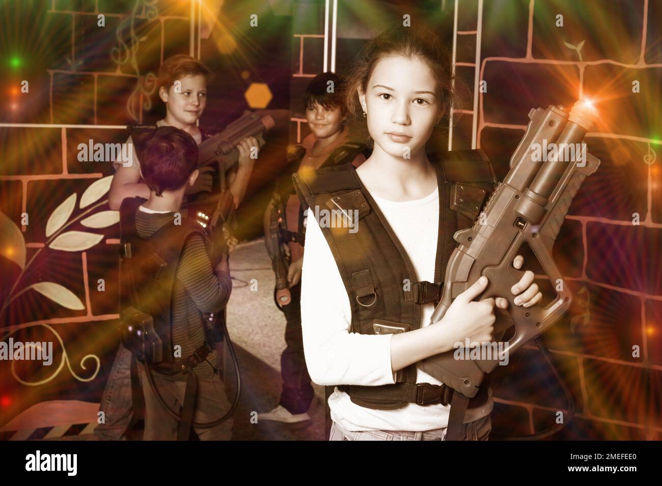 girl with laser pistol posing in laser tag labyrinth Stock Photo - Alamy