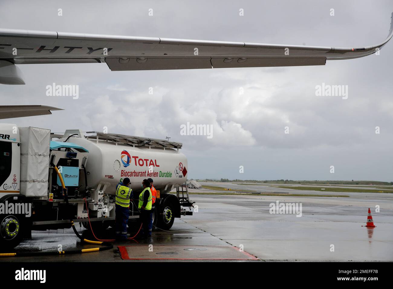 Workers refuel an Airbus A350 with sustainable aviation fuel at Roissy ...