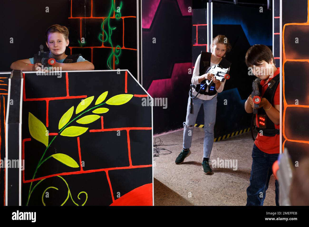 Kids playing laser tag on labyrinth Stock Photo - Alamy