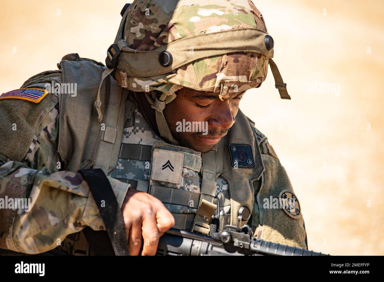 Cpl. Tyrone Robinson check his rifle during a live-fire engagement with ...