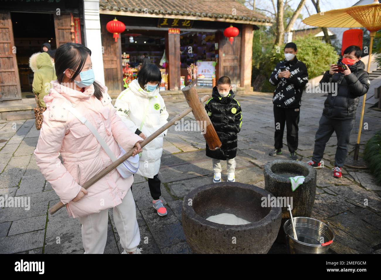 Hangzhou, China's Zhejiang Province. 24th Jan, 2023. Tourists help make ...