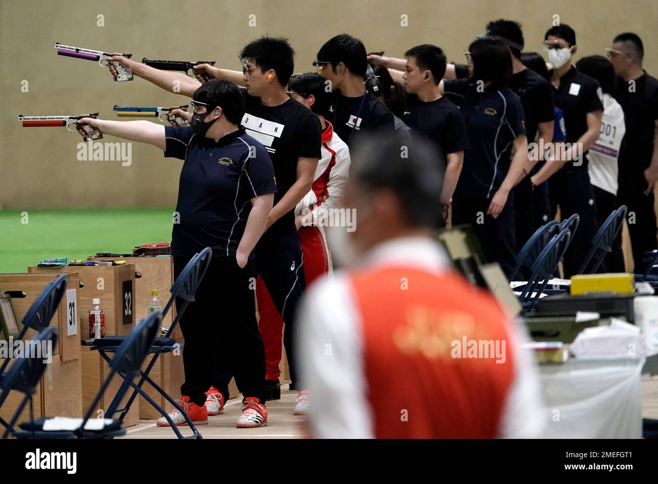 Local athletes compete in a qualification round of the 10m Air Pistol ...