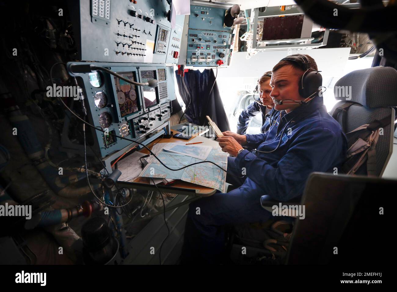 Russian military cargo plane Il-76 crew members work during a flight to ...
