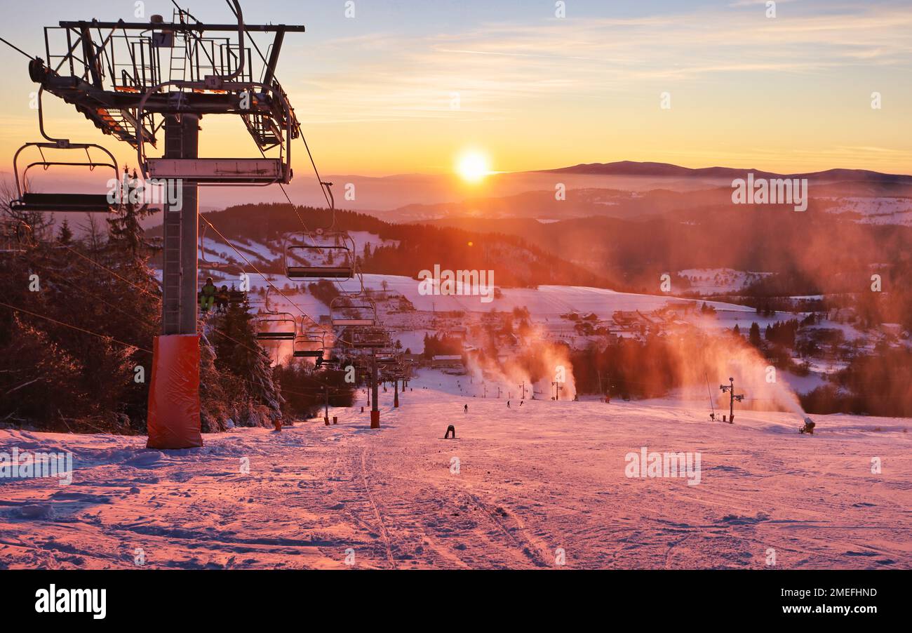Colorful winter sunset lift ski resort in Krahule mountains in Slovakia ...