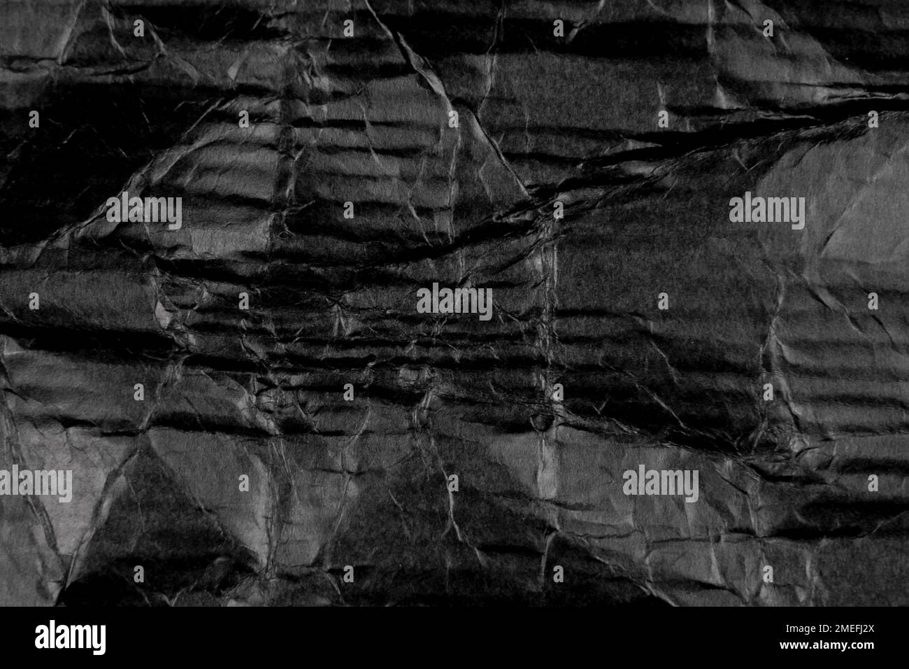 Black paper textured abstract background with crumples and wrinkles ...