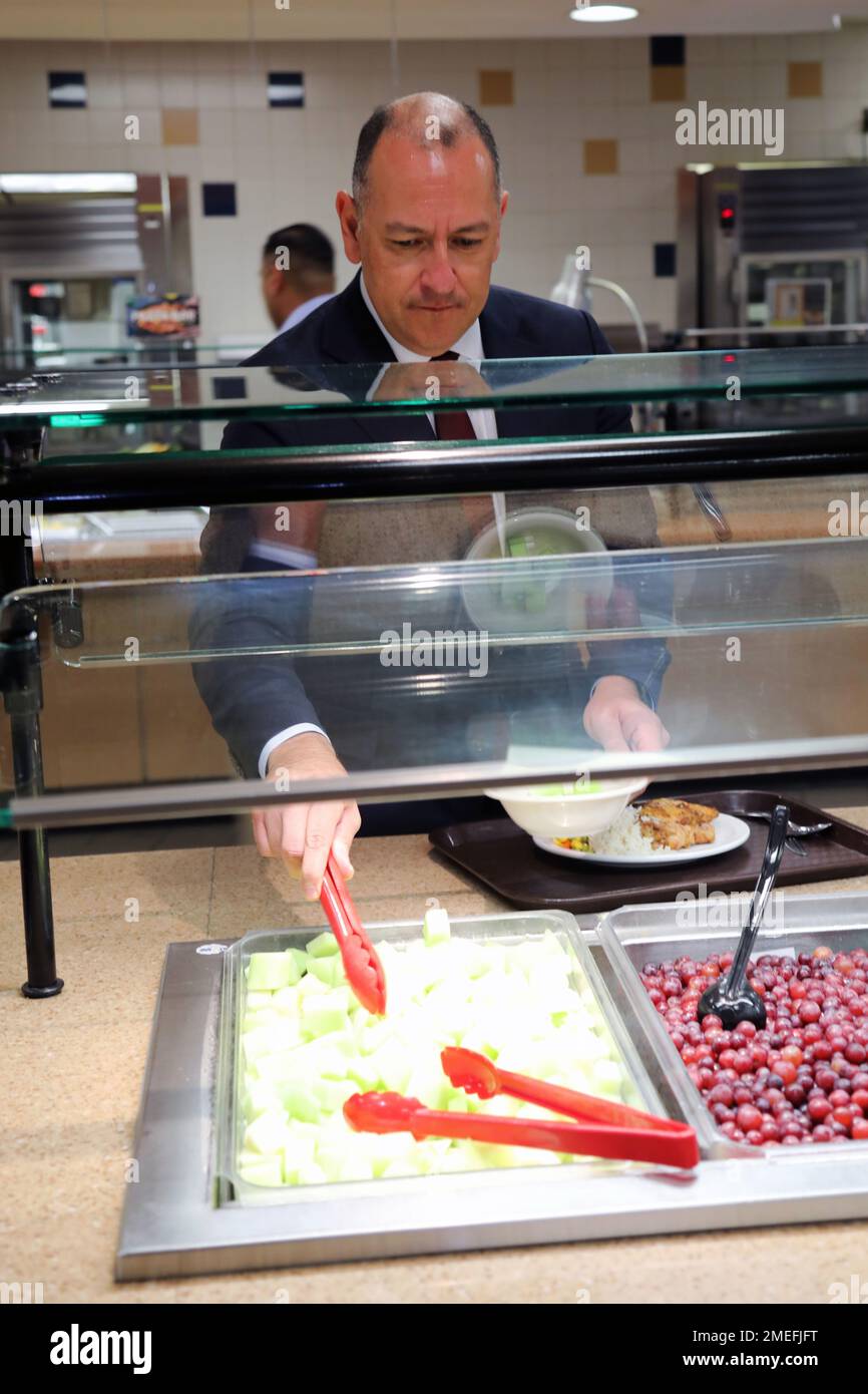 The Under Secretary of the Army, Hon. Gabe Camarillo gets food from a ...