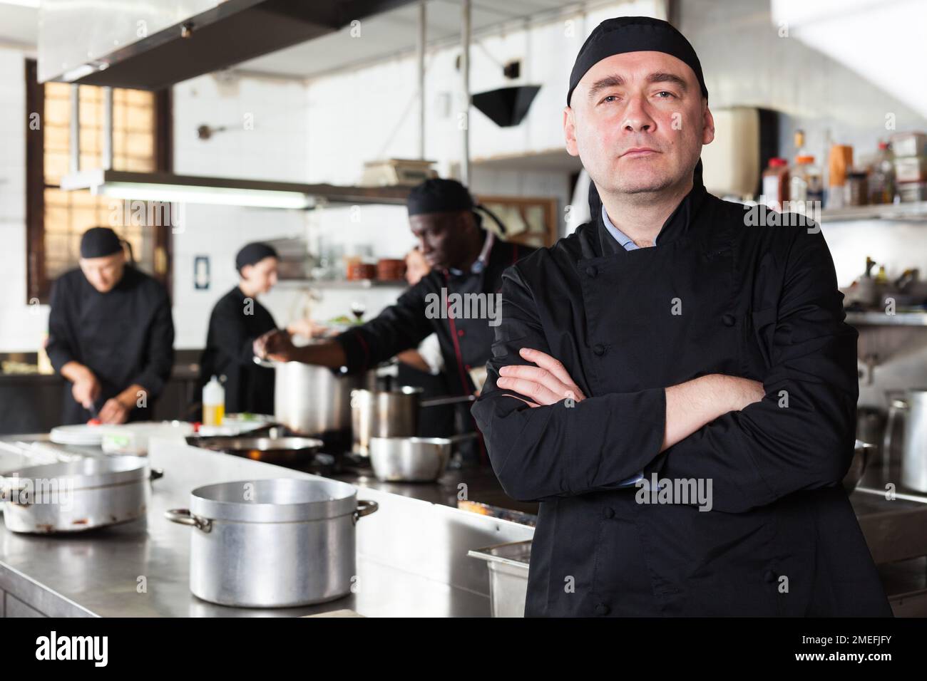 Confident male chef posing at restaurant kitchen Stock Photo - Alamy