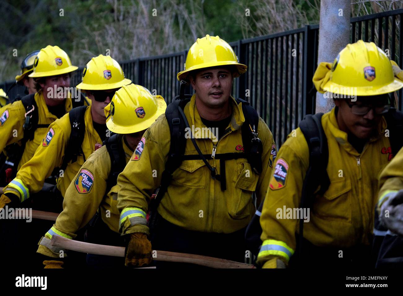Members of the Hotshots fire crew walk in line during a wildfire in the ...