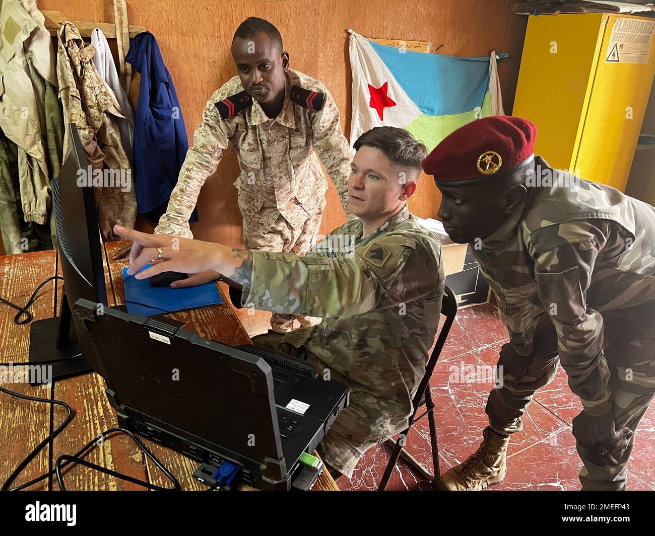 Kentucky National Guard Staff Sgt. Jeffrey Reno, middle, assists ...