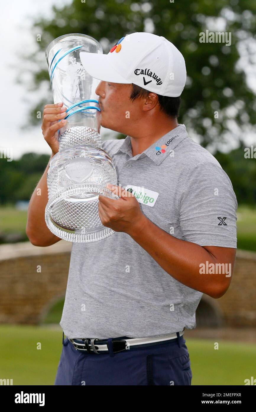 Kyoung-Hoon Lee, of South Korea, kisses the trophy on the 18th green ...