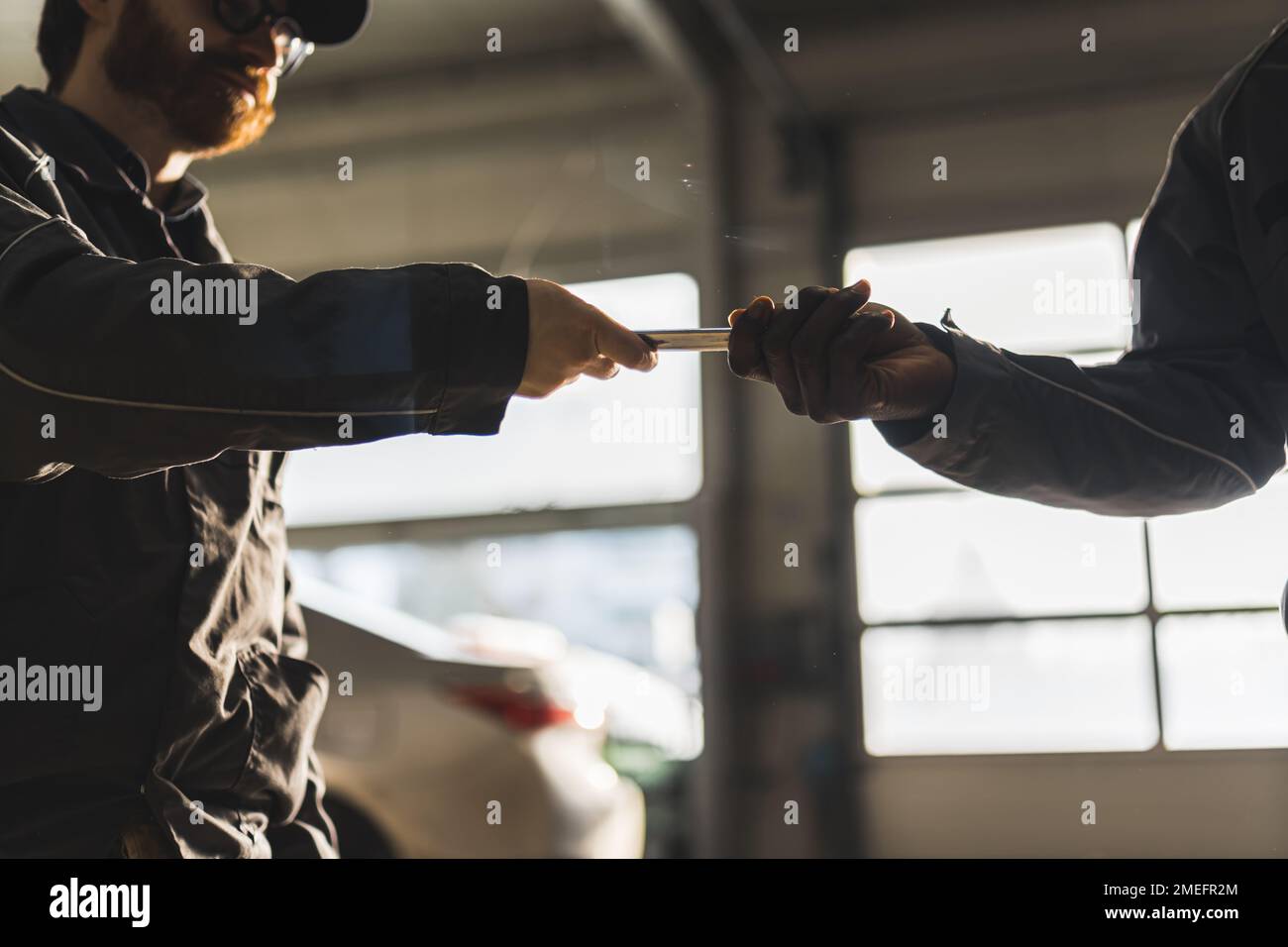 Low angle shot. Two hands of male mechanics holding a spanner. Repair ...