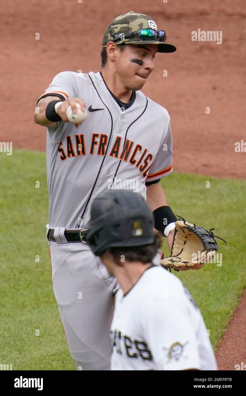 San Francisco Giants second baseman Mauricio Dubon, top, fakes a throw ...
