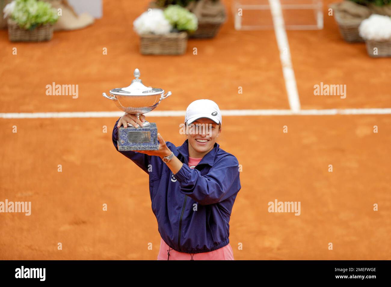 Poland's Iga Swiatek holds the winner's trophy after defeating Czech ...