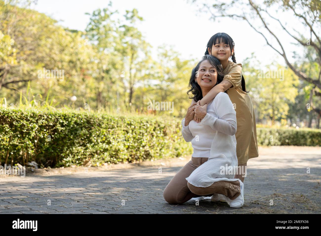 Happy granddaughter and her grandmother at summer park, family, leisure ...