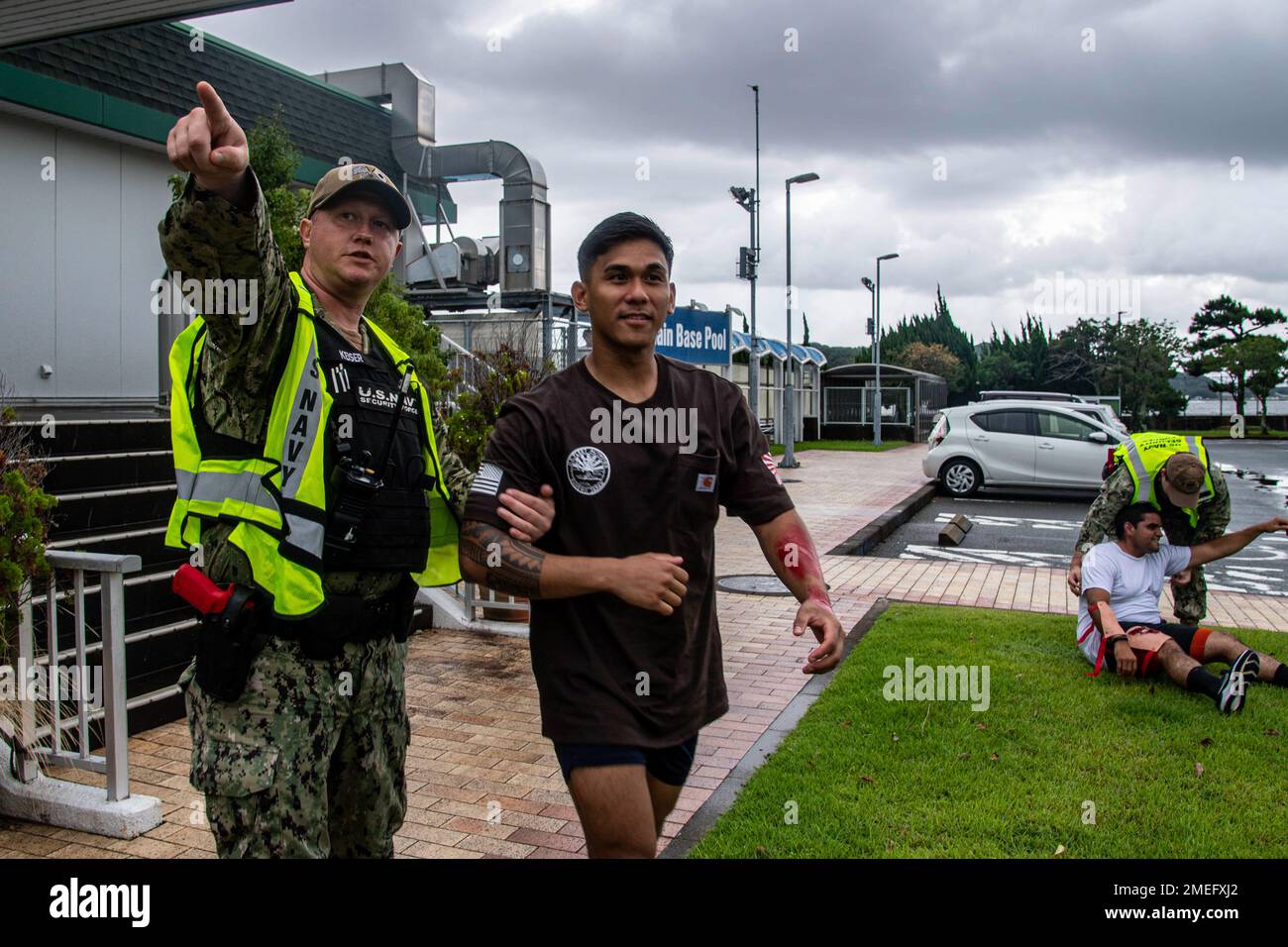Master-at-Arms 3rd Class Bradley Keiser assists Operations Specialist ...