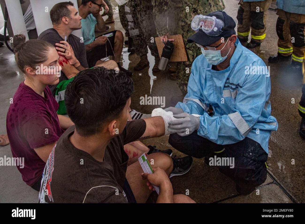 Operations Specialist 2nd Class Bryan Samson receives assistance from ...