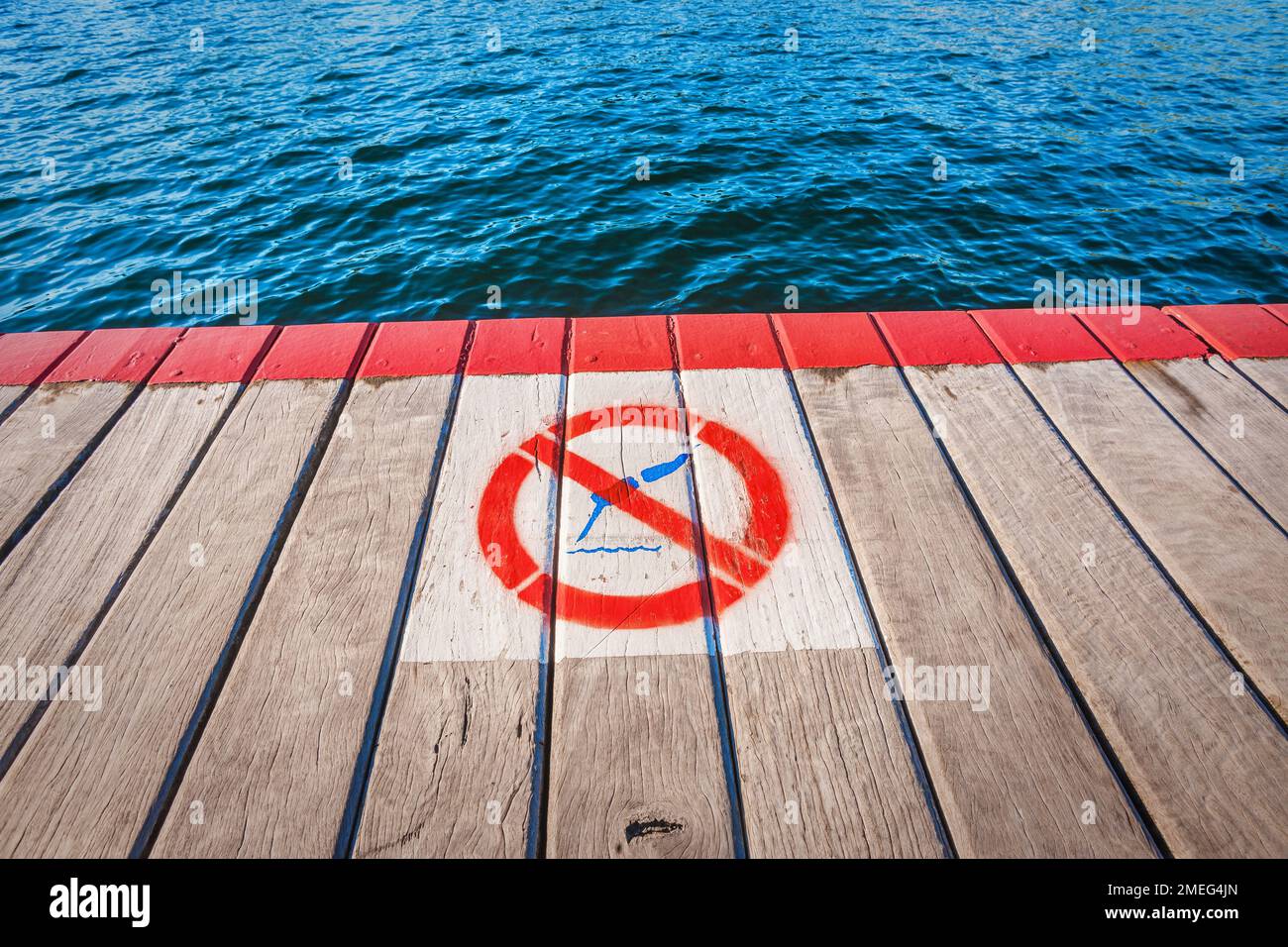 No diving sign painted on wooden walkway Stock Photo - Alamy