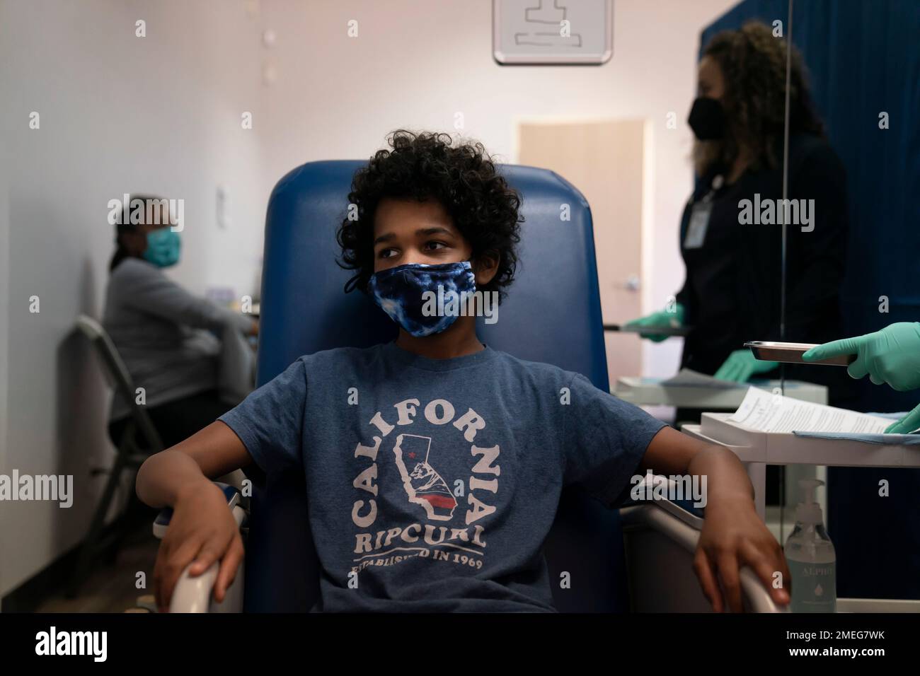 Marcus Morgan, 14, waits to receive his Pfizer COVID-19 vaccineat ...