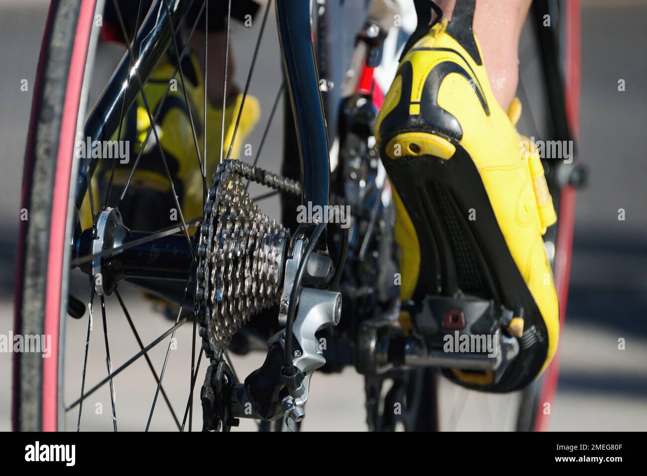 Cycling racing- bike detail on gear wheels and feet Stock Photo - Alamy