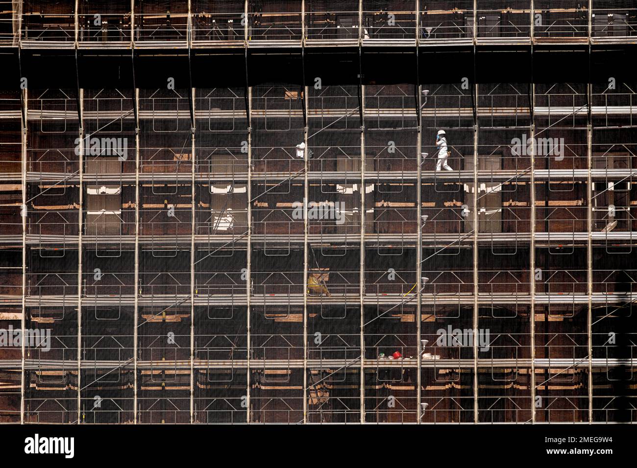 A worker walks on a scaffolding in downtown Rome, Thursday, May 13 ...